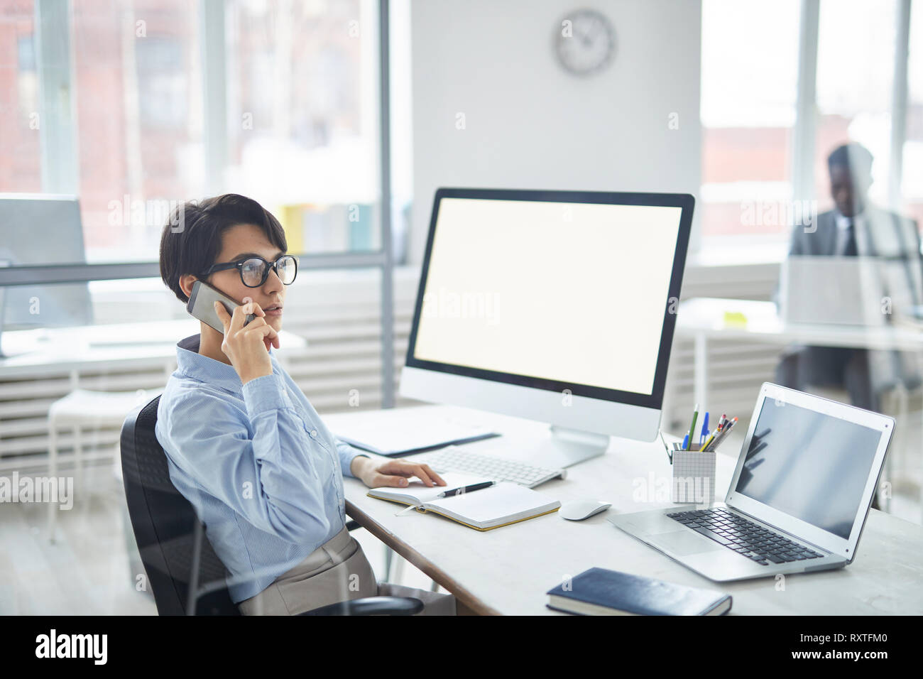 Talking to client on the phone Stock Photo - Alamy