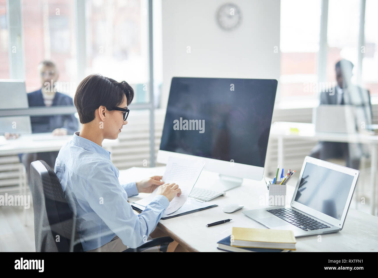 Young employee reading contract hi-res stock photography and images - Alamy