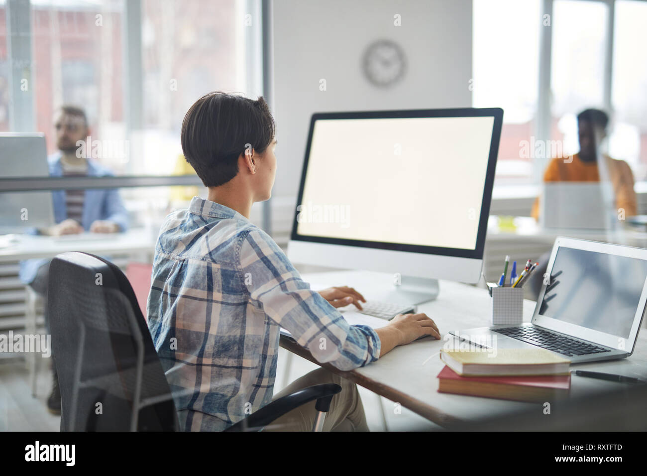 Working in front of monitor Stock Photo - Alamy