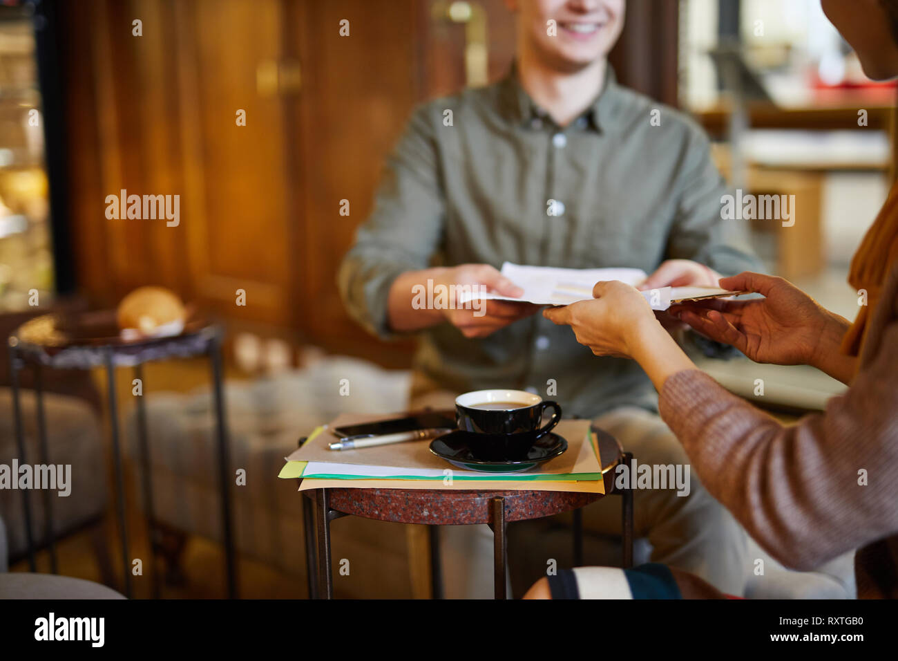 Hand passing papers hi-res stock photography and images - Alamy