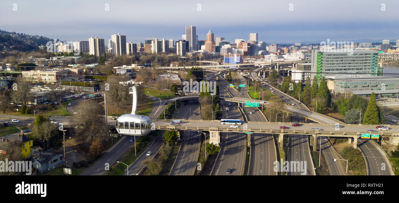 The cable car is full of riders exploring Portland via aerial ...