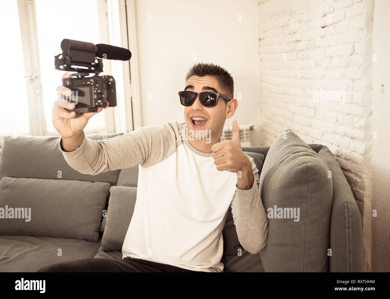 Life style portrait of young happy male blogger on camera screen ...