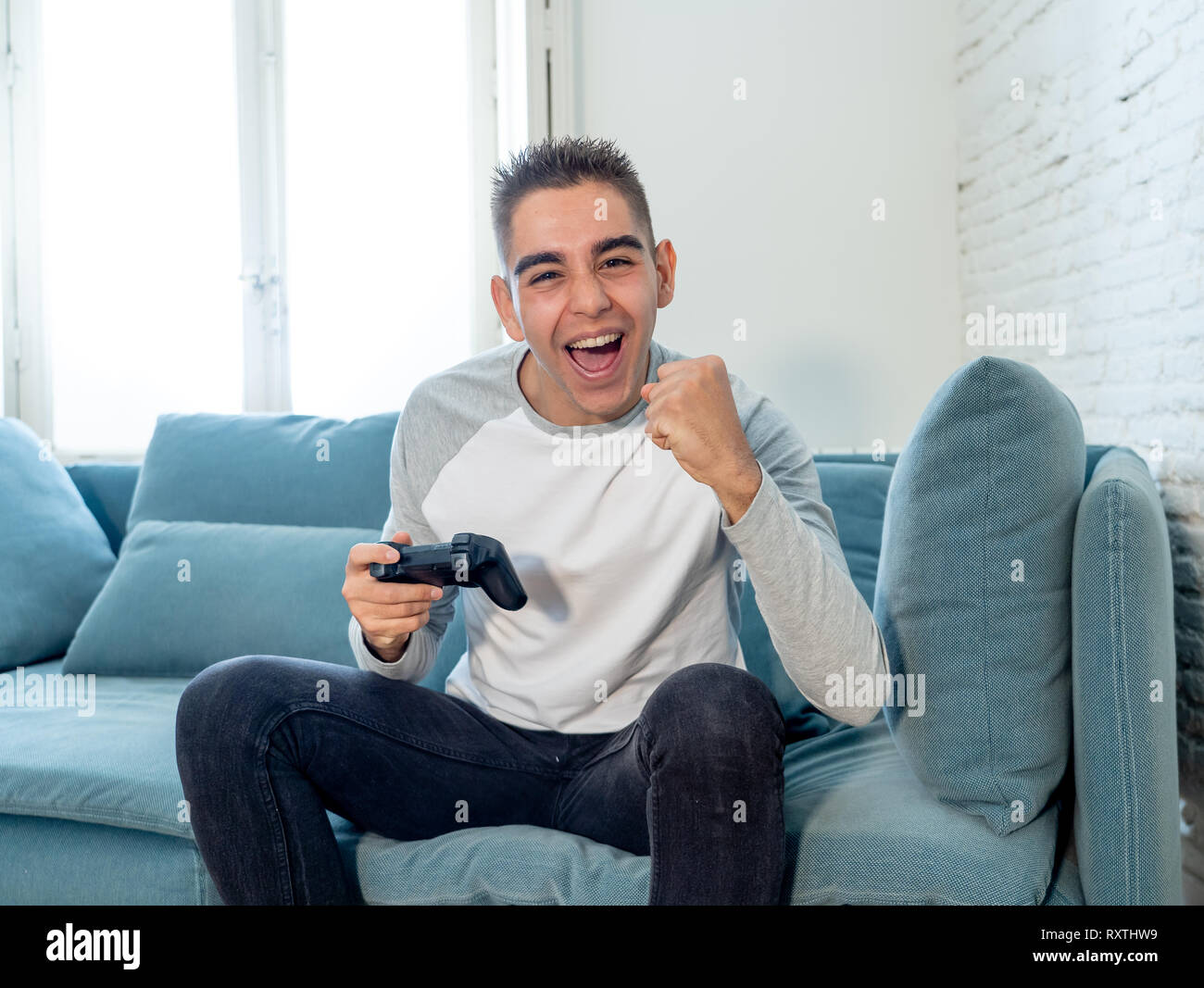 Portrait of young student man playing video games having fun winning ...