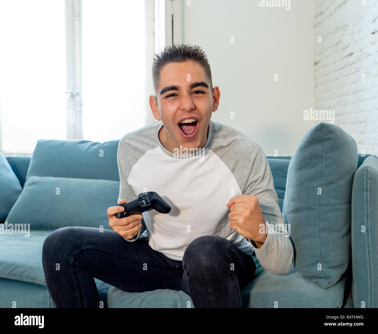 Portrait of young student man playing video games having fun winning ...