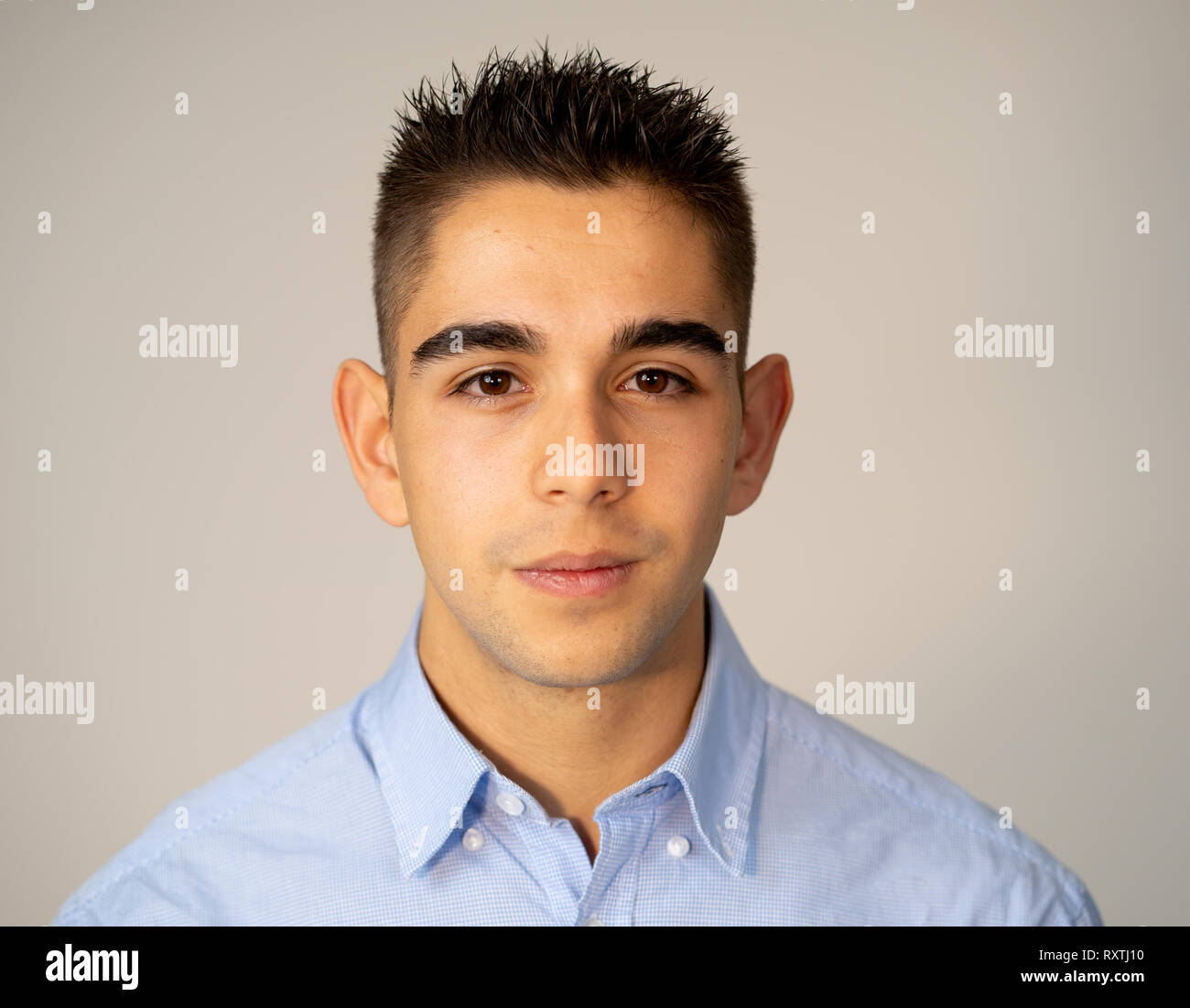 Close up portrait of attractive, confident young man looking neutral ...