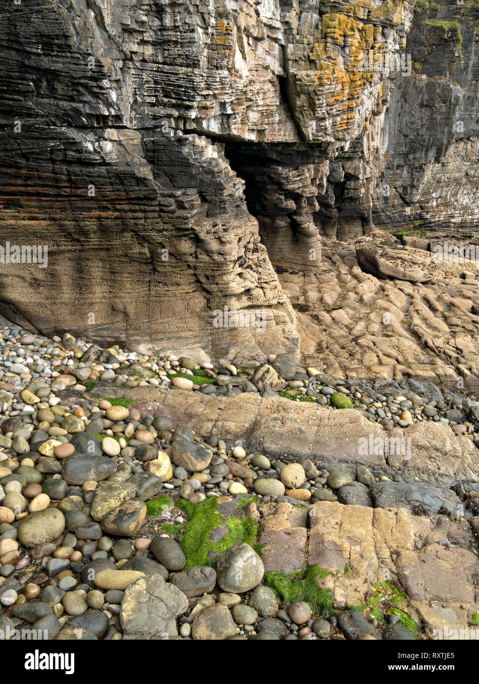 Eroded rocks sea cliffs and sea caves on shoreline near Elgol on the ...