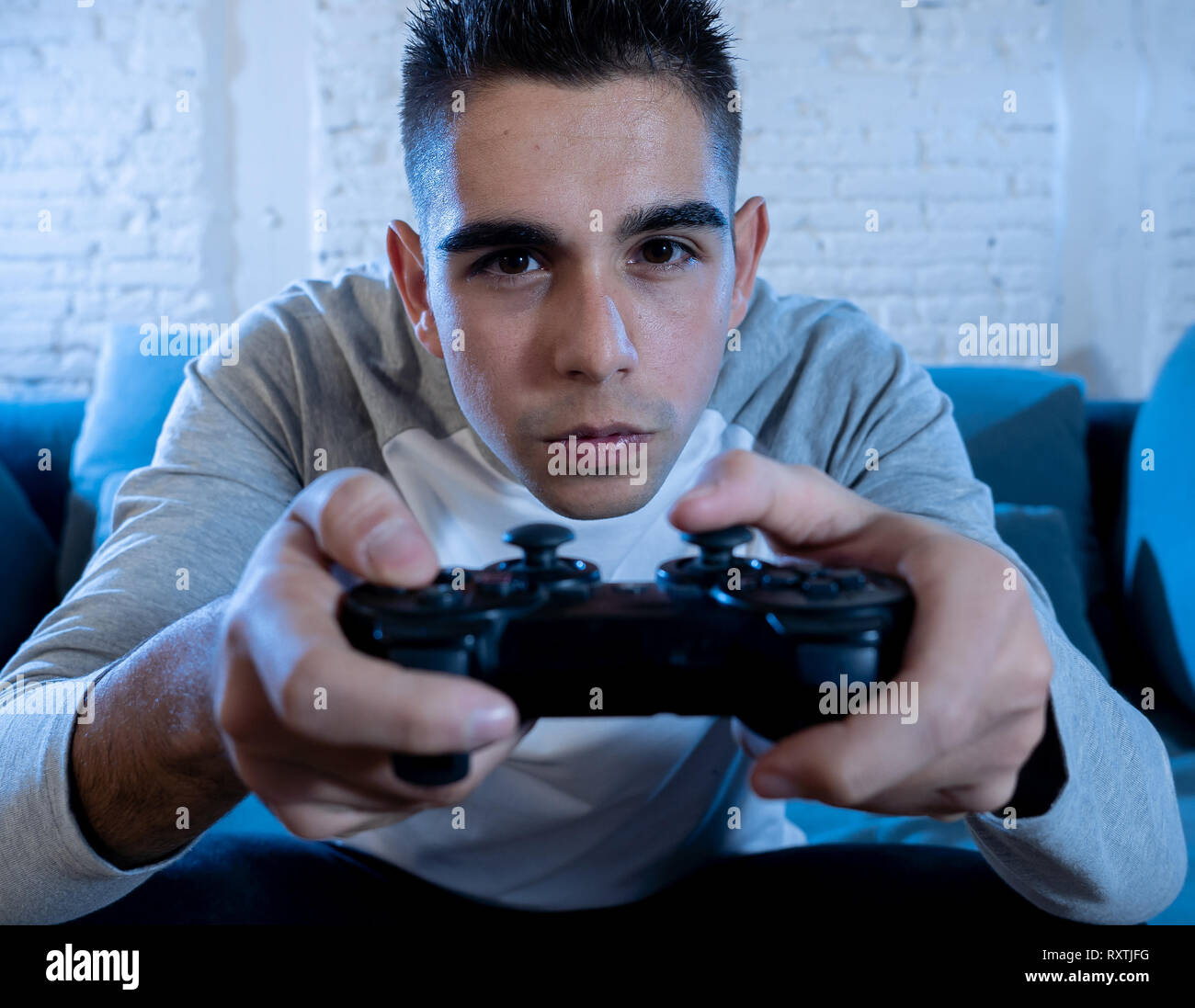 Portrait of young student man playing video games at night using ...