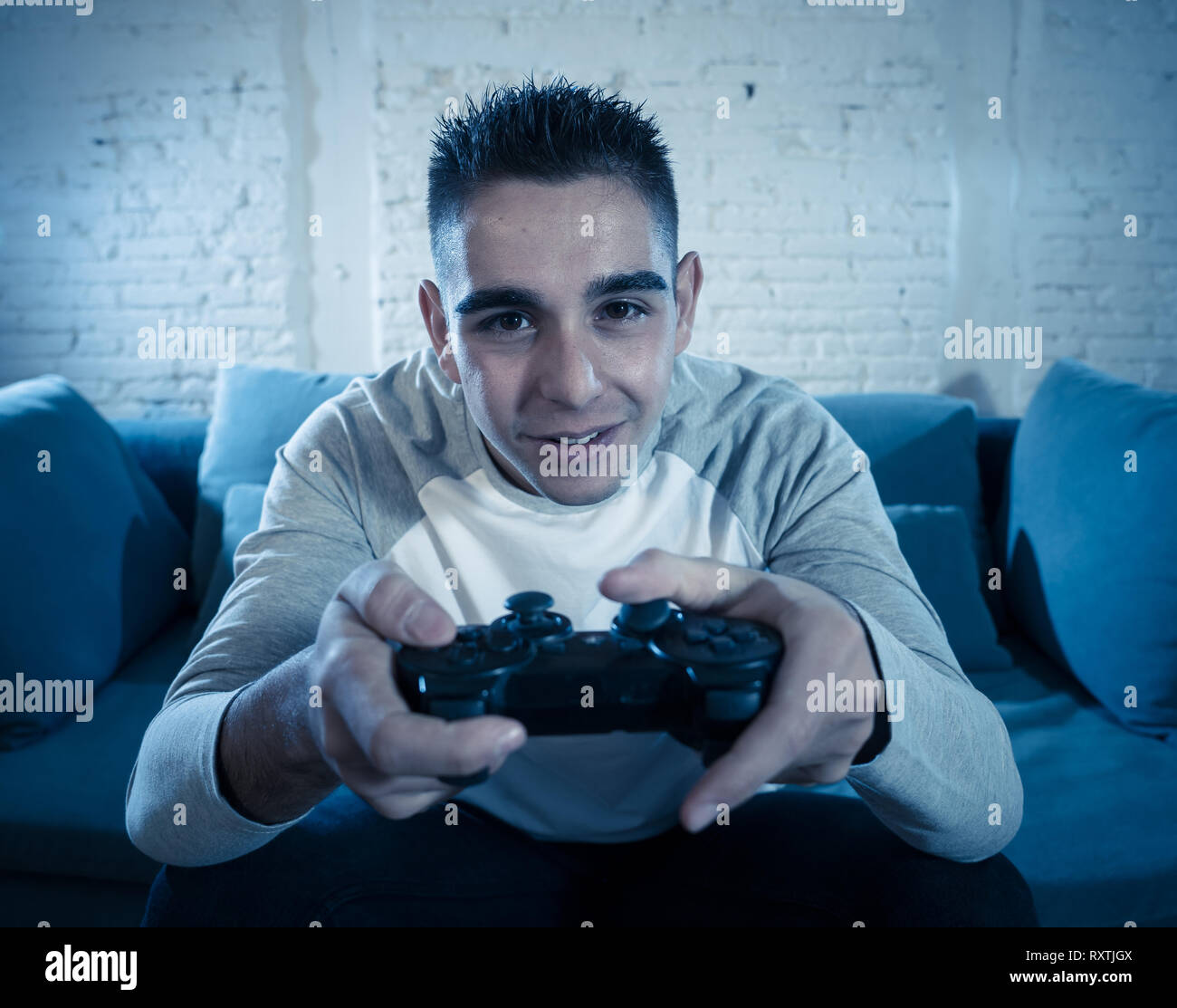 Portrait of young student man playing video games at night using ...