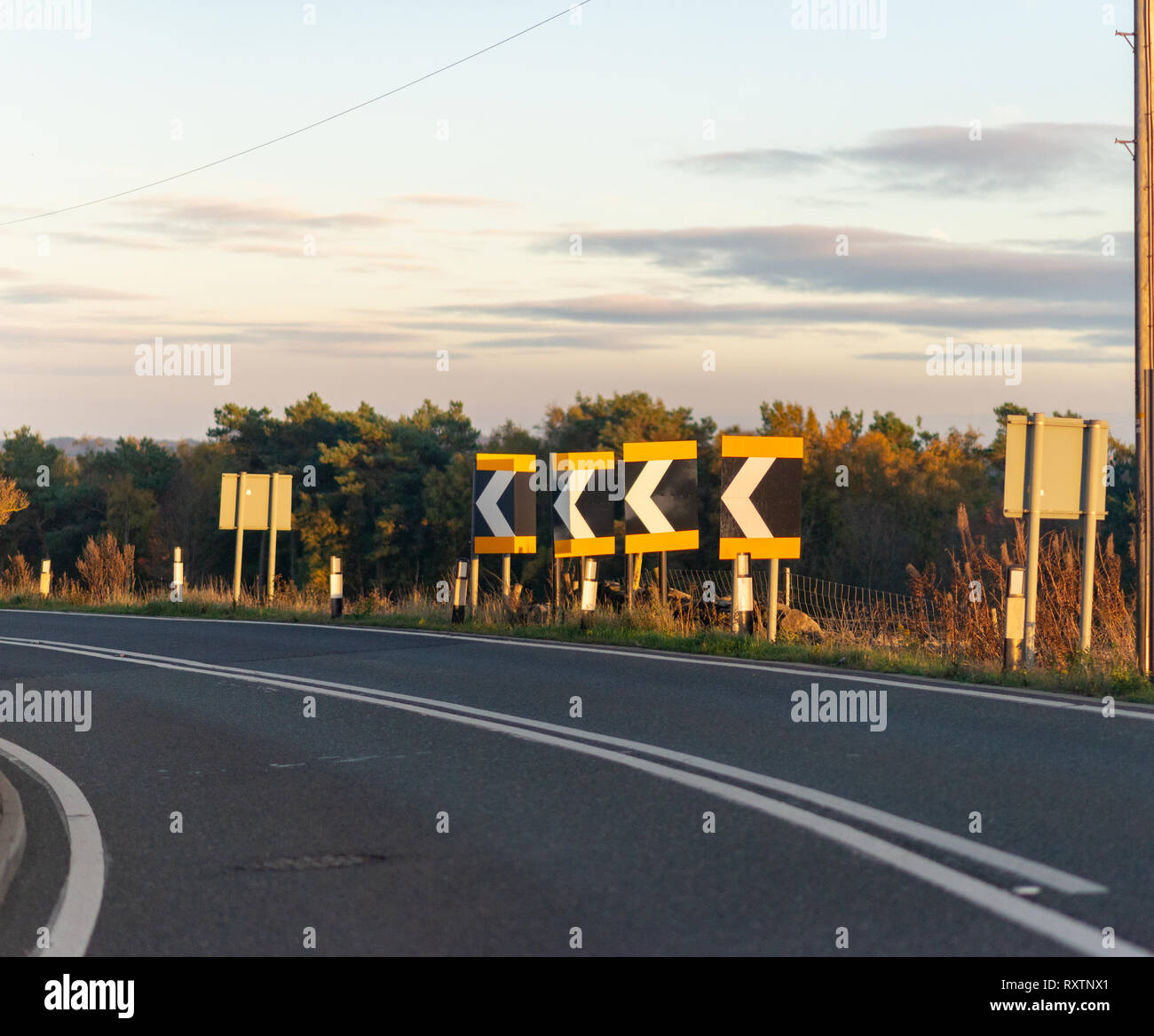 A series of signs warn drivers of a sharp bend in the UK Stock Photo ...