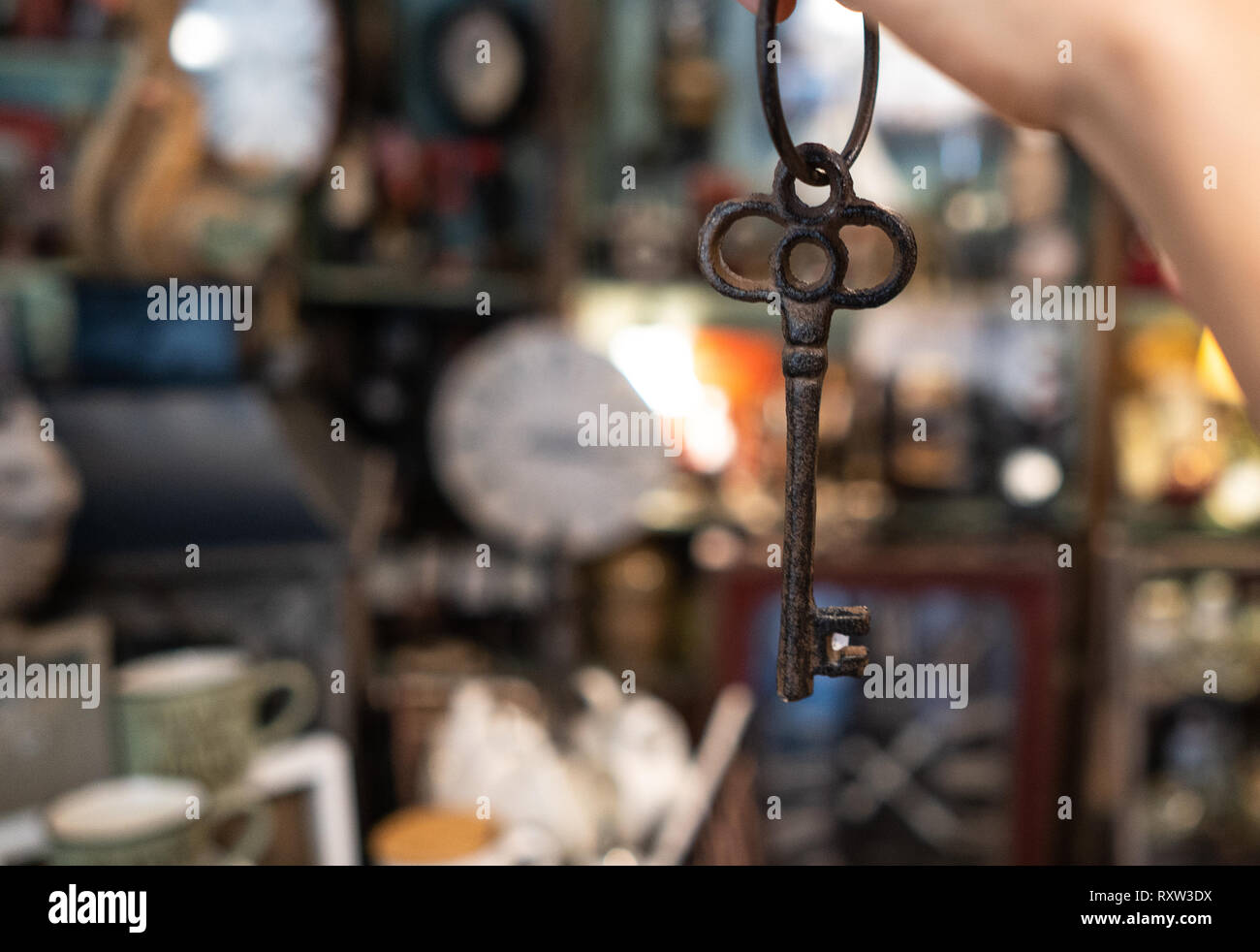 woman's hand holding an antique key on blurred background Stock Photo ...