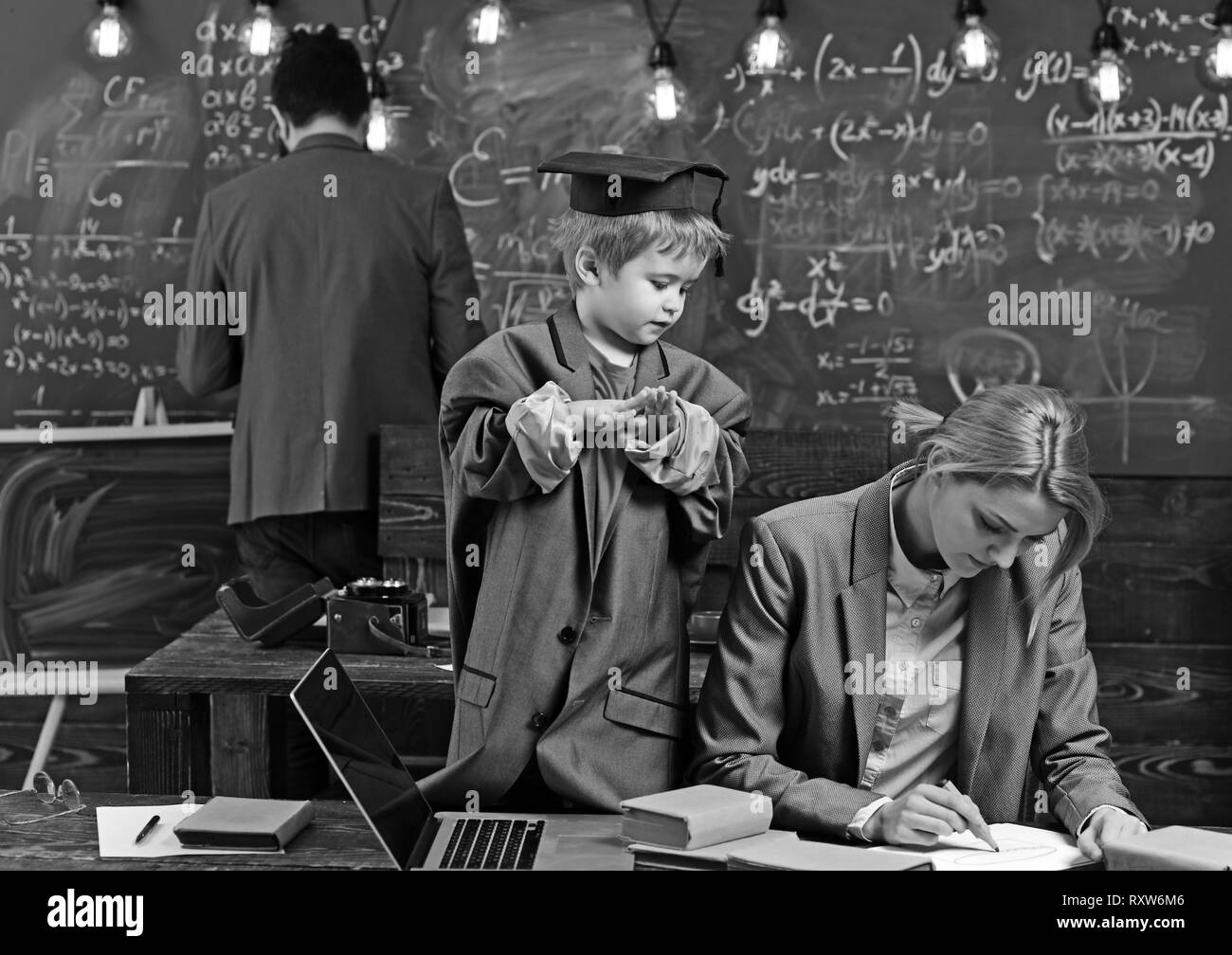 Family and little child have lesson in classroom. Family enjoy school ...