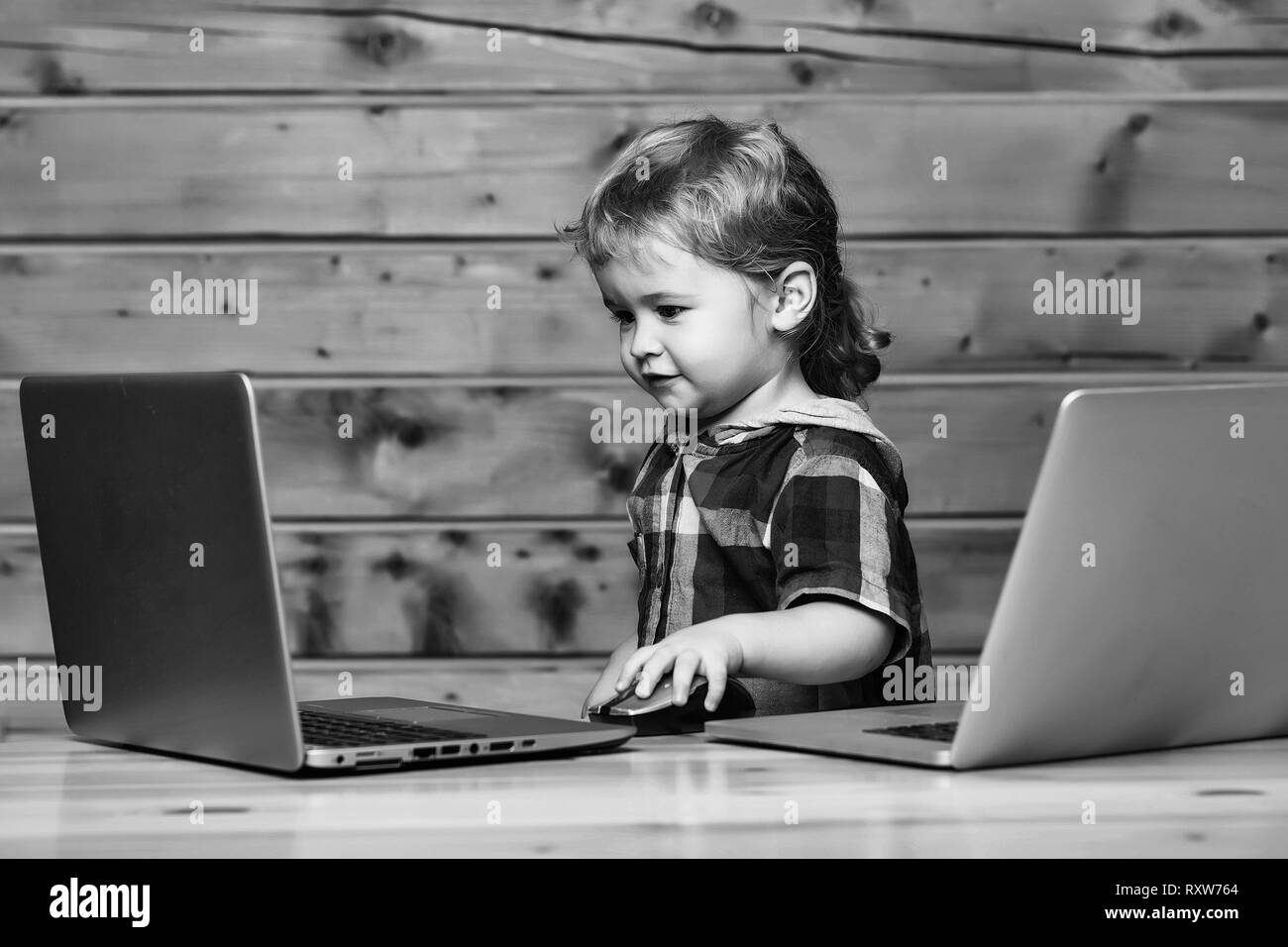 Cute boy plays on computers Stock Photo - Alamy