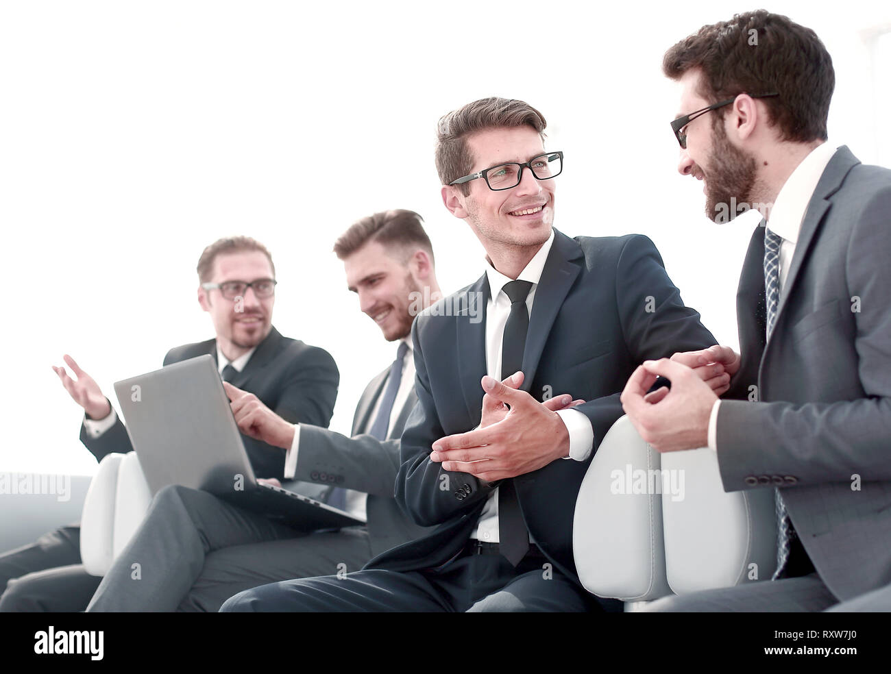 group of business people talking sitting in the office waiting room ...