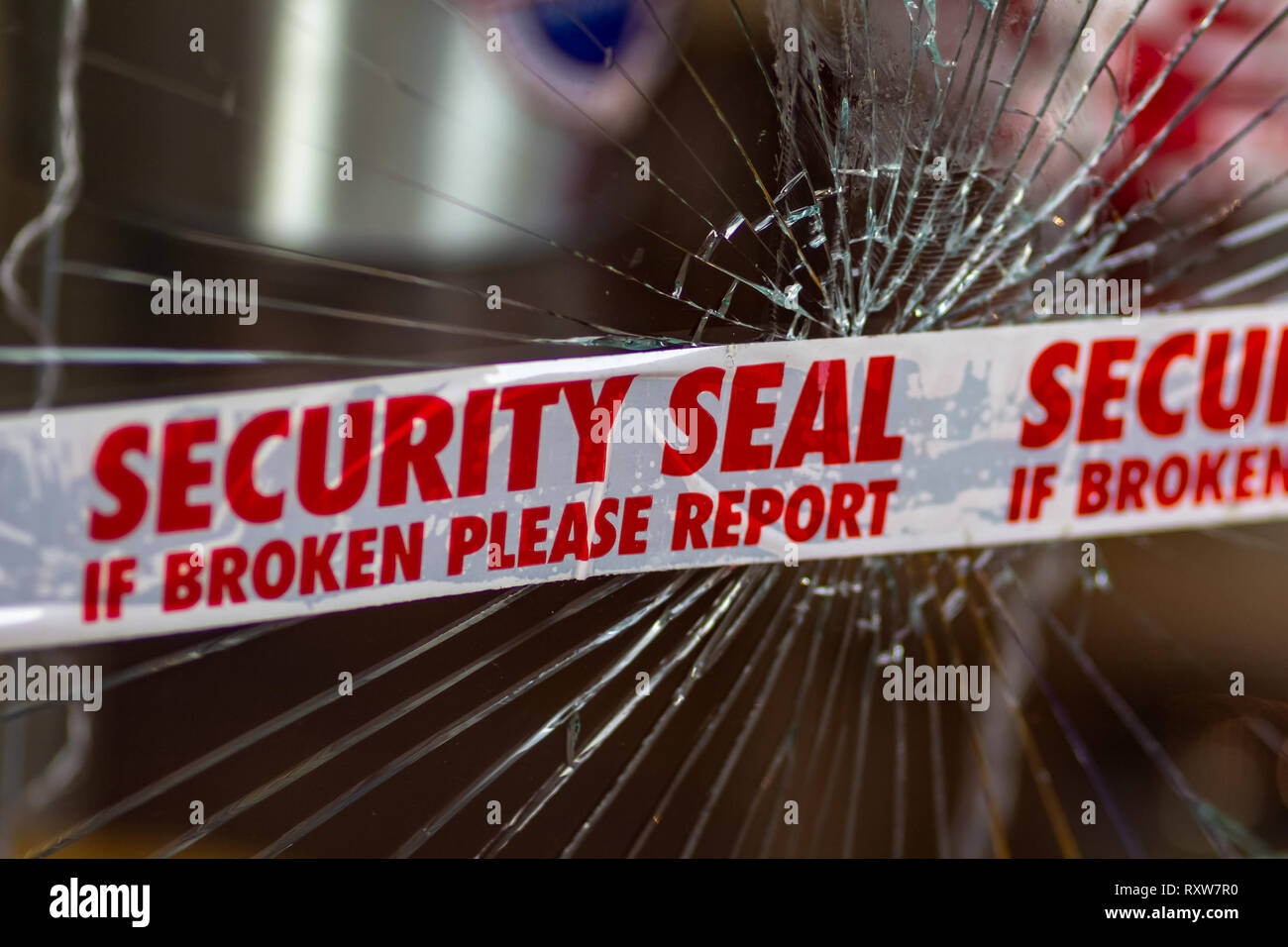 Police Security Seal tape across the broken glass window Stock Photo ...