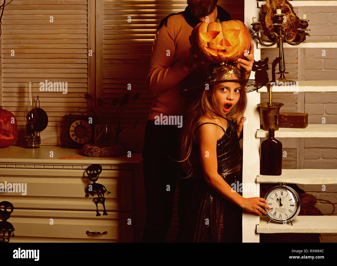 Small child with alarm clock on halloween. Small girl ready to ...