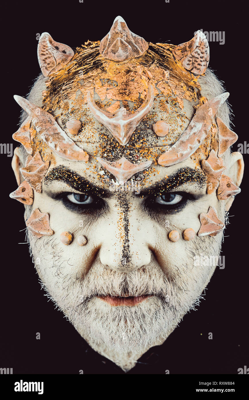 Head with thorns or warts, face covered with glitters, close up. Demon ...