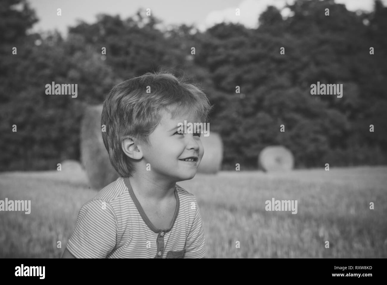 Little child smile at field with hay bales, agriculture Stock Photo - Alamy