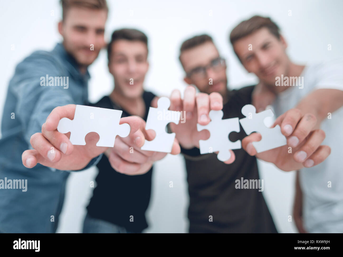group of young people with puzzle pieces Stock Photo - Alamy