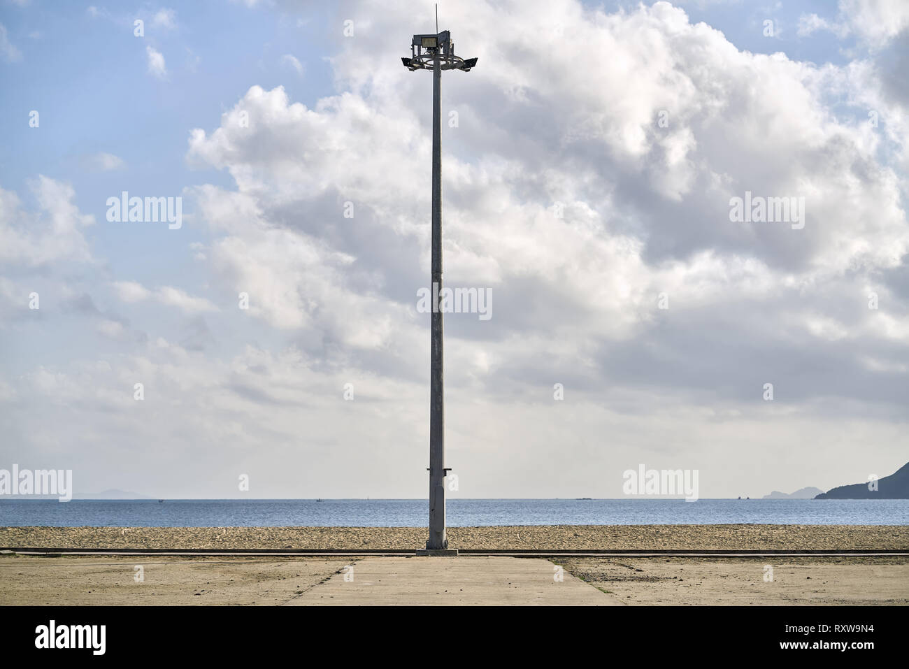 Wonderful sand beach with a street light on the sunny background of the ...