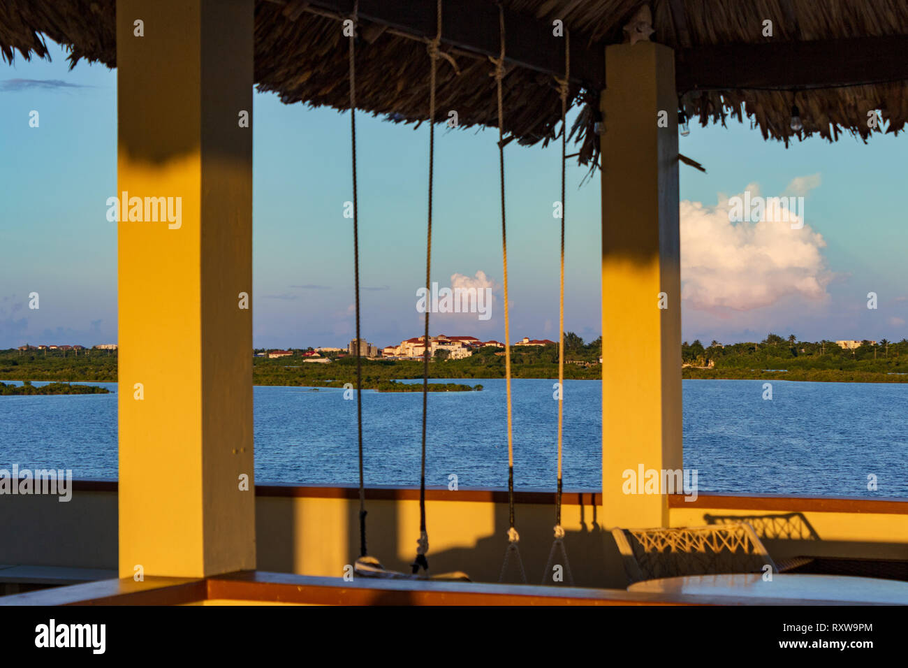 Peering from under a palapa roof toward San Pedro, Ambergris Caye ...