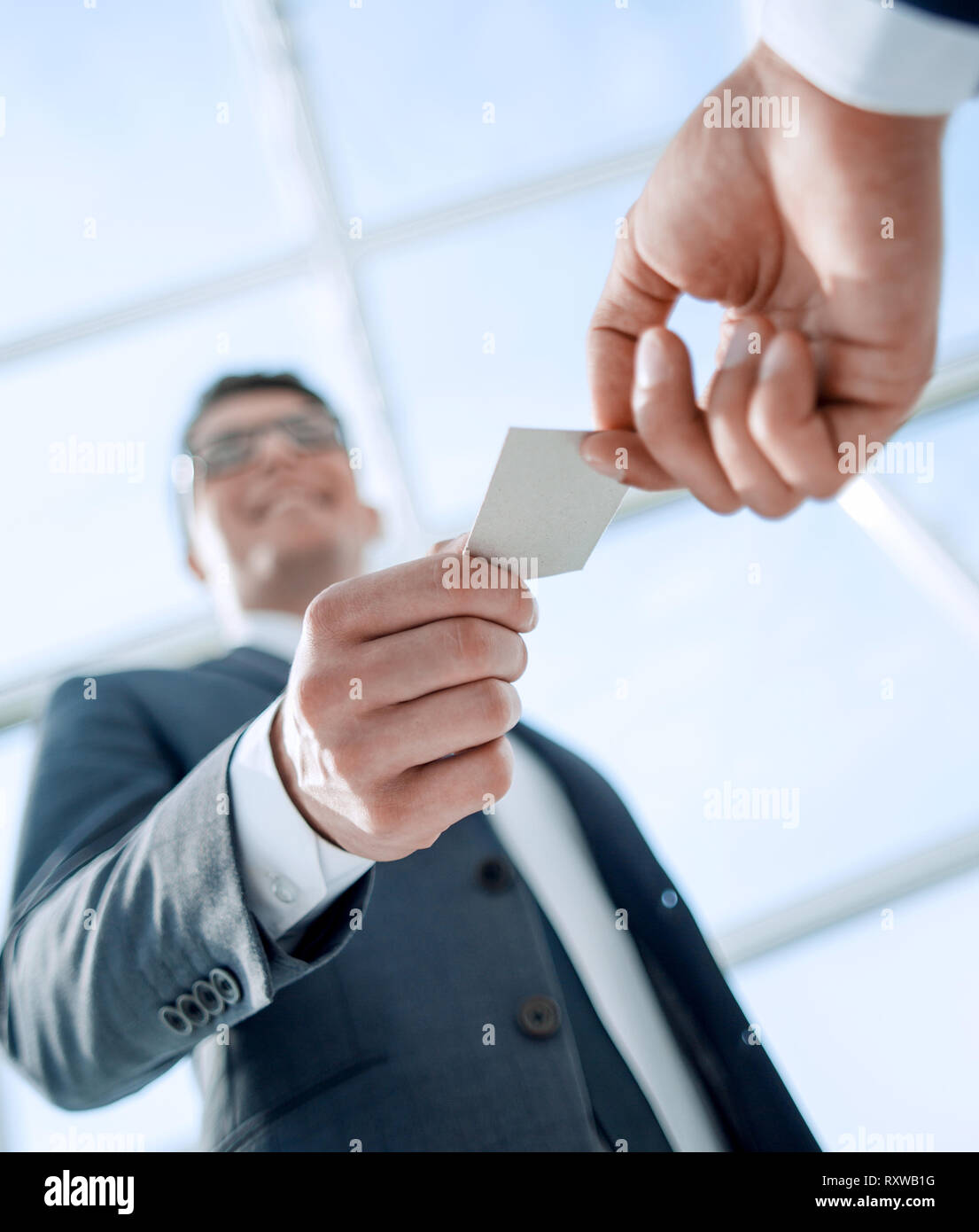 Two businessmen exchanging business card hi-res stock photography and ...
