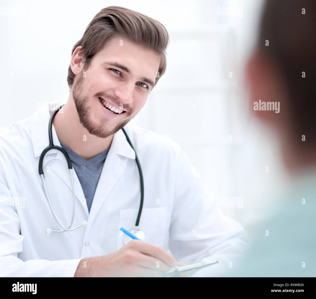 closeup.doctor writing a prescription to her patient Stock Photo - Alamy