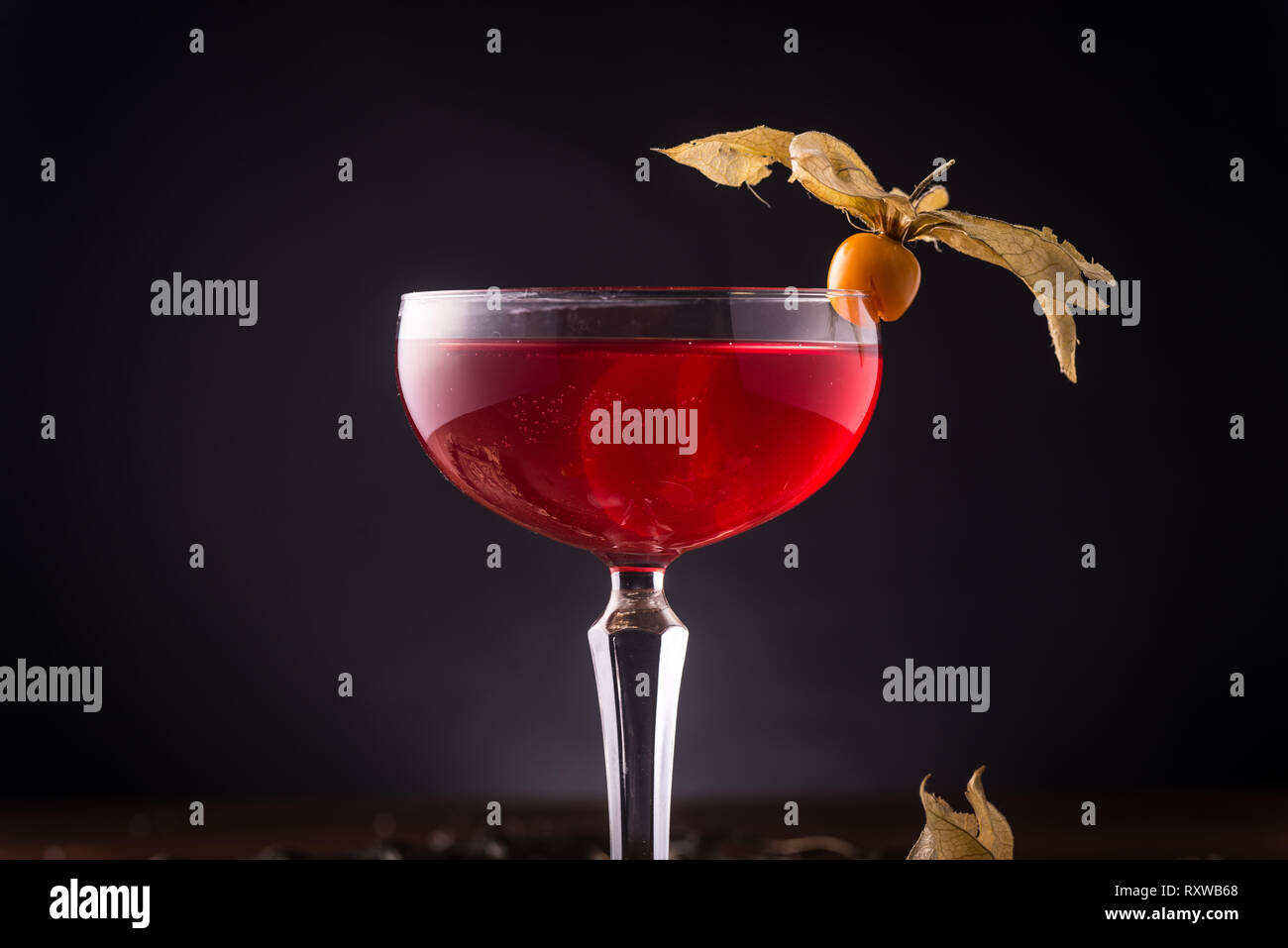 Colour Cocktail on dark wooden background Stock Photo - Alamy