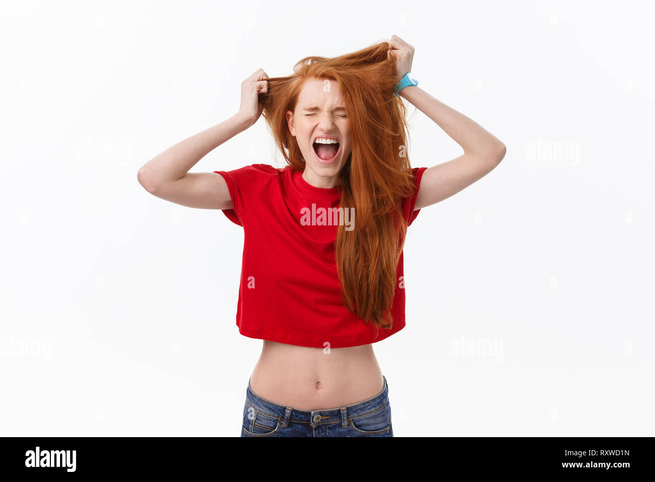 Picture of angry young woman standing isolated over white background ...
