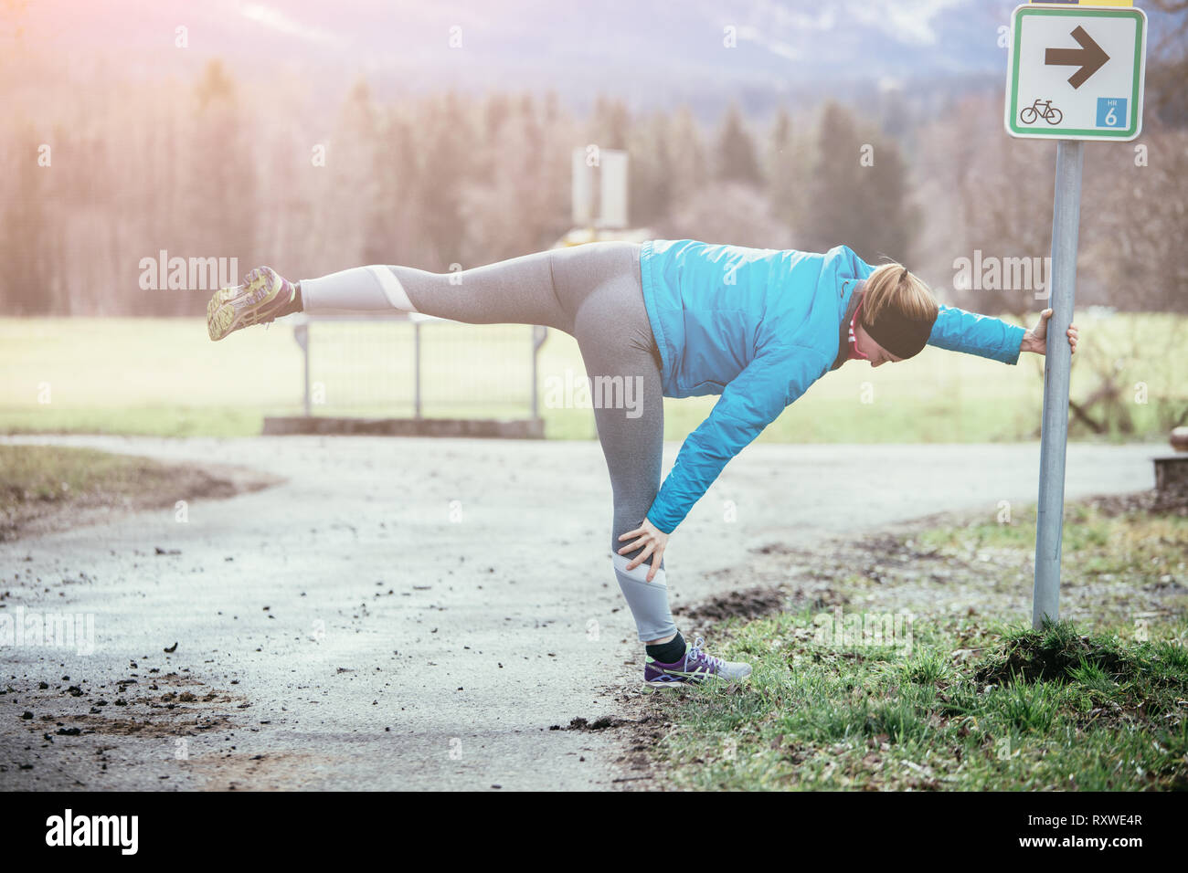 Young woman is bending and stretching before going to run Stock Photo ...