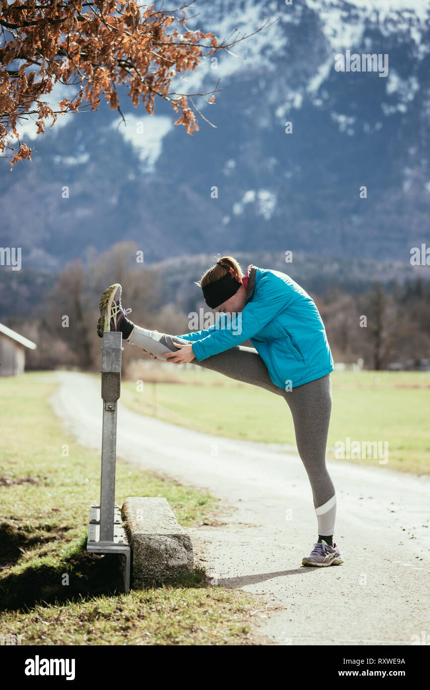 Young woman is bending and stretching before going to run Stock Photo ...