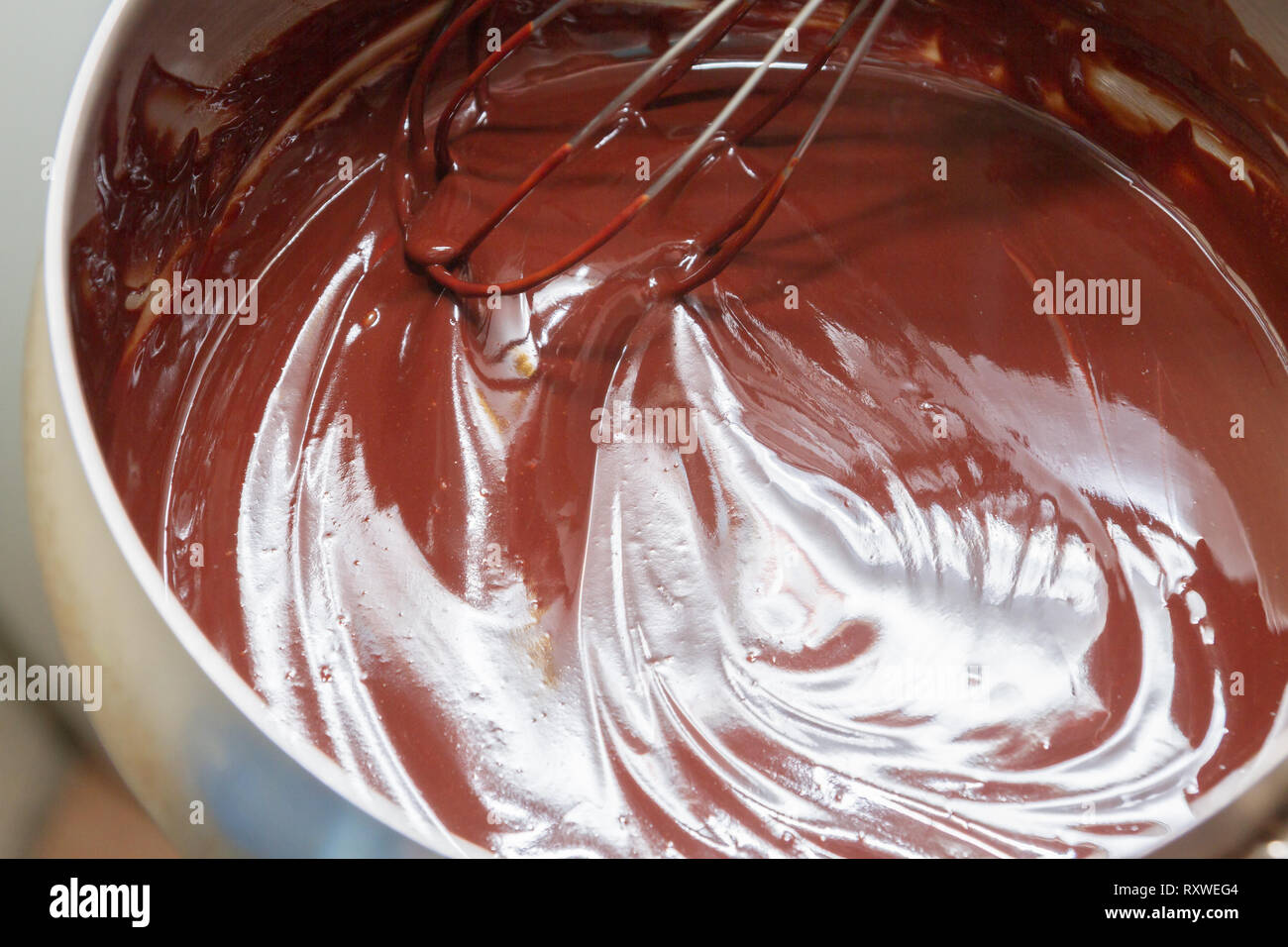 Thorough mixing of the liquid chocolate for dessert cooking Stock Photo ...