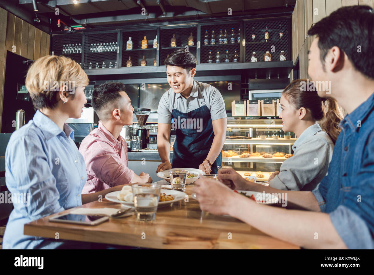 Waiter serving food hi-res stock photography and images - Alamy