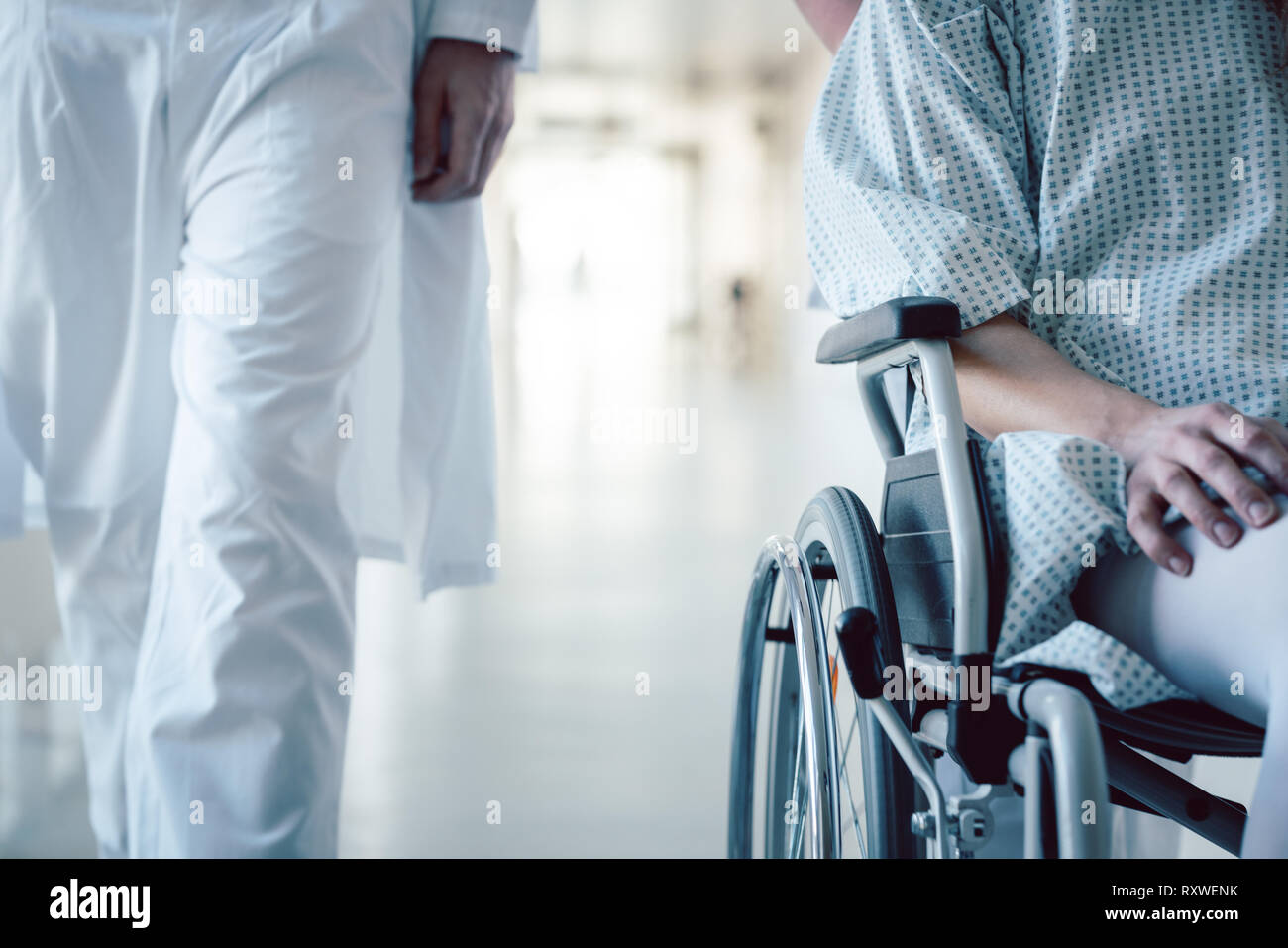 Doctor and nurse pushing wheelchair with patient in hospital Stock ...