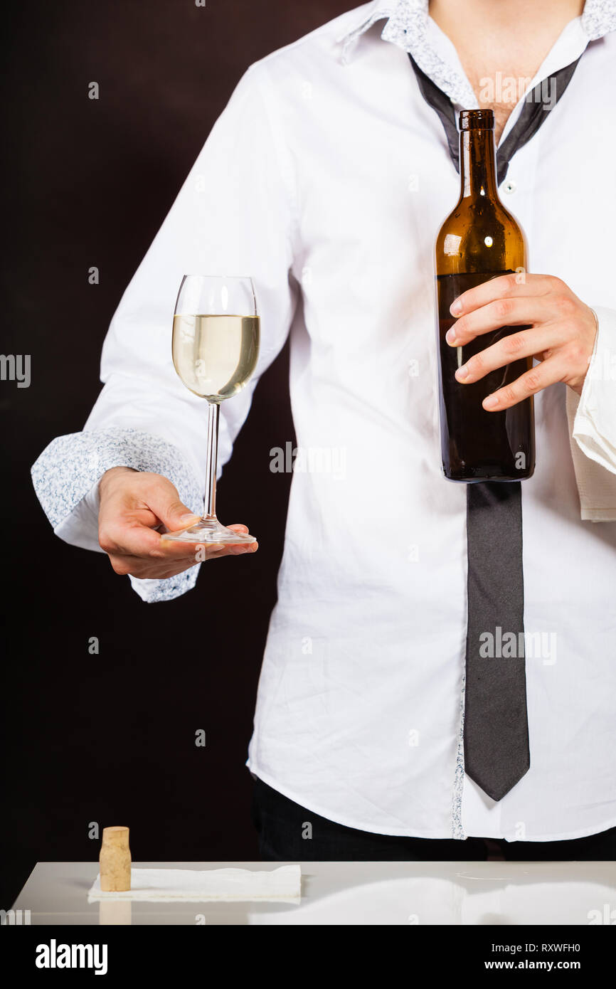 Male waiter or butler serving pouring white wine into glass Stock Photo ...