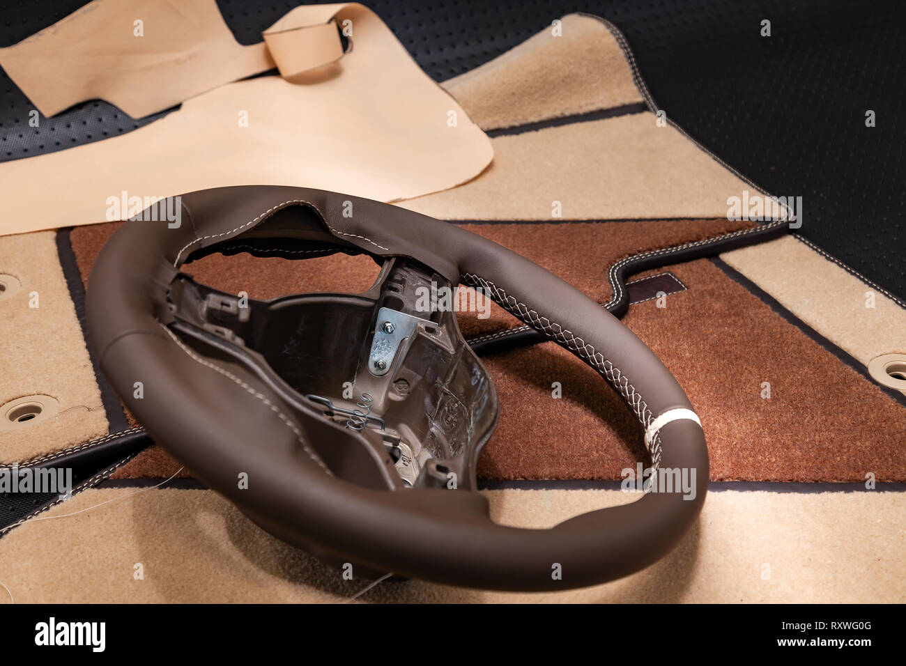 Leather steering wheel brown color in the process of stitching with a ...
