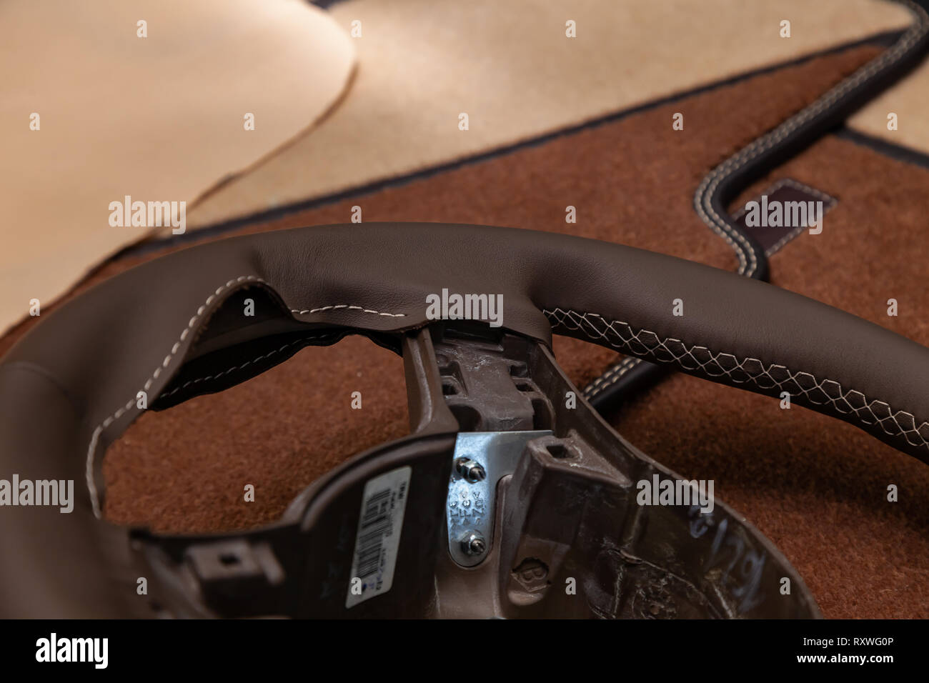 Leather steering wheel brown color in the process of stitching with a ...