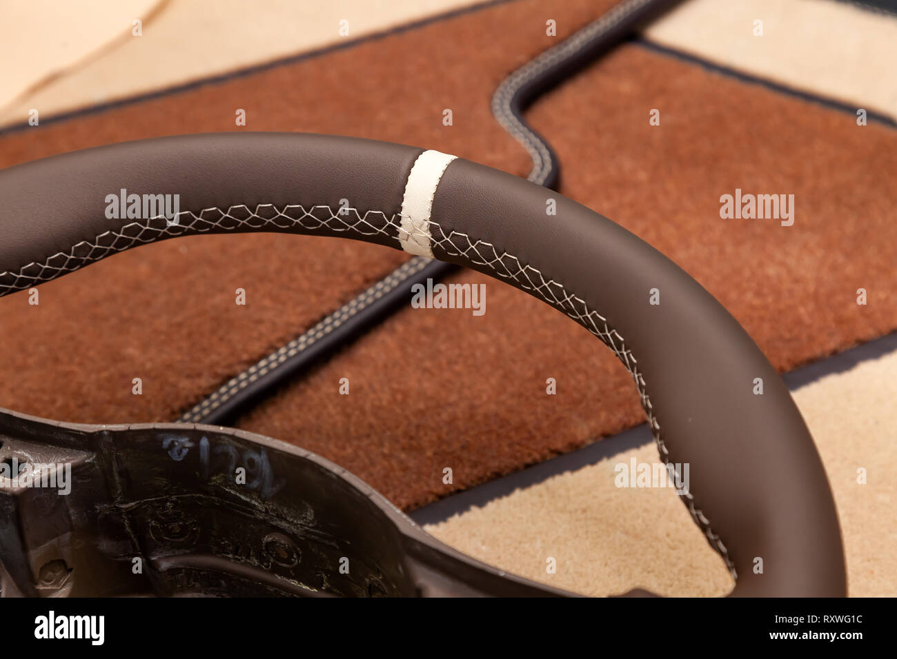 Leather steering wheel brown color in the process of stitching with a ...