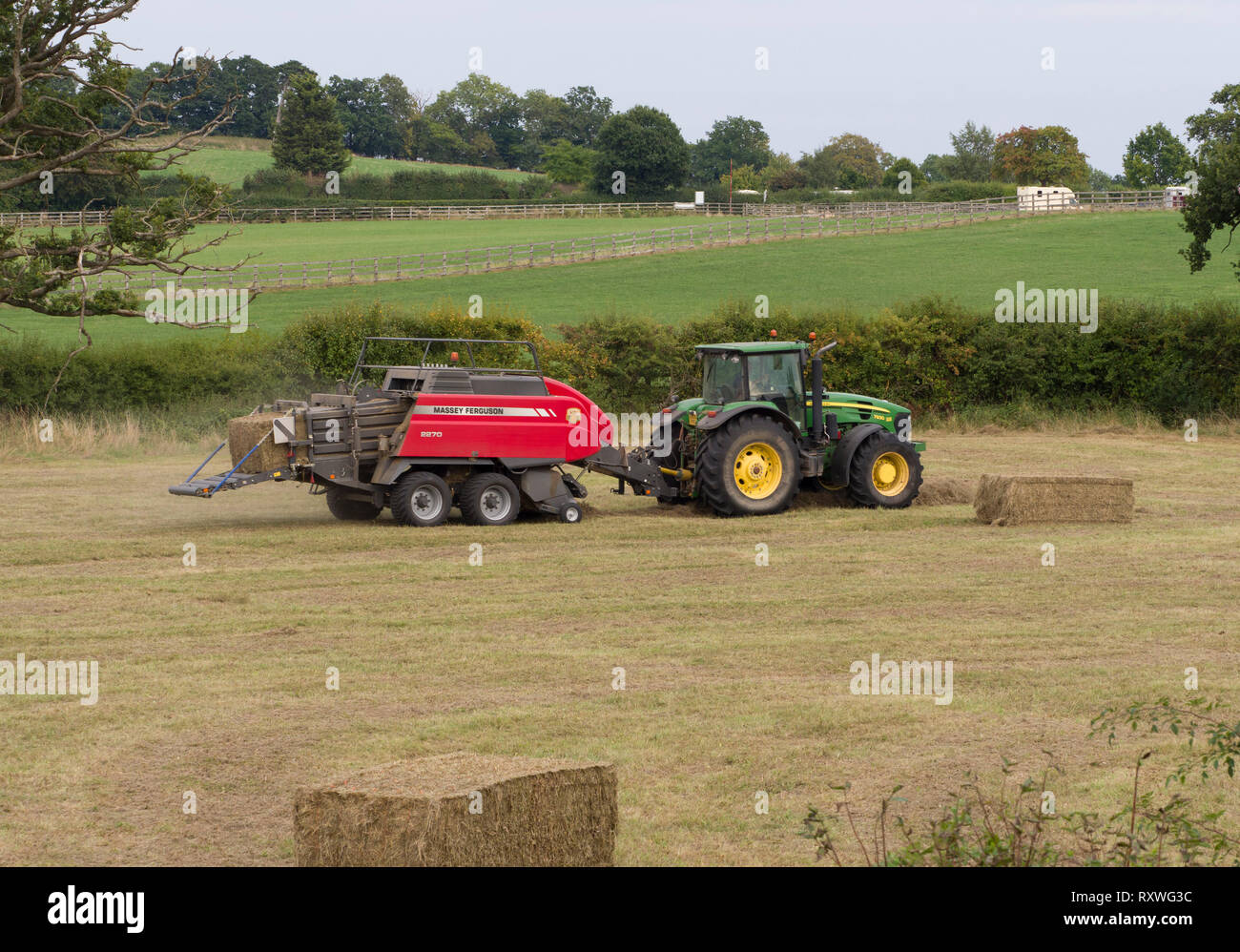 Hay baler and tractor harvesting hay in field, Worcestershire, UK Stock ...