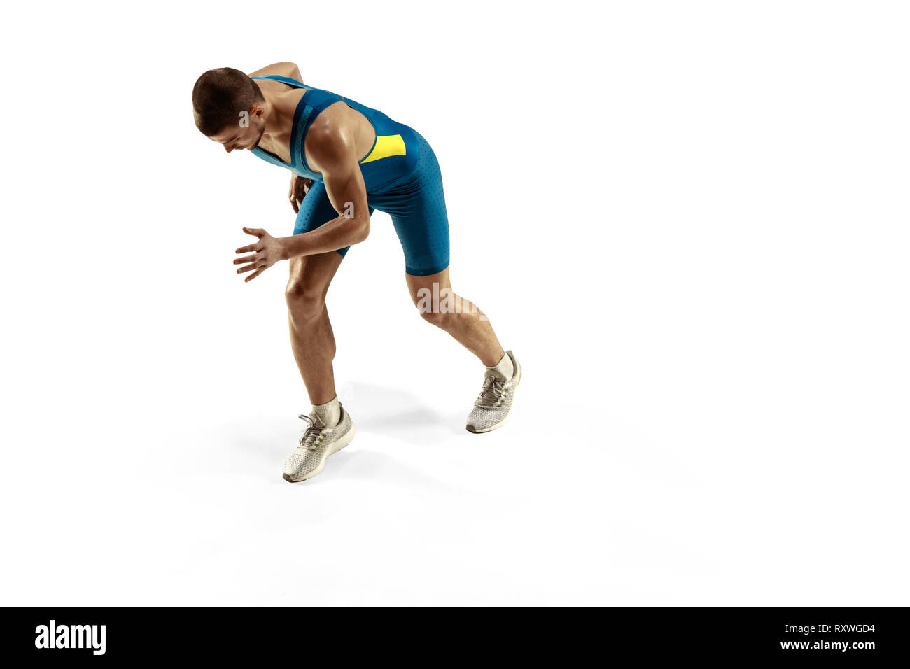 Young caucasian man running isolated on white studio background. One ...