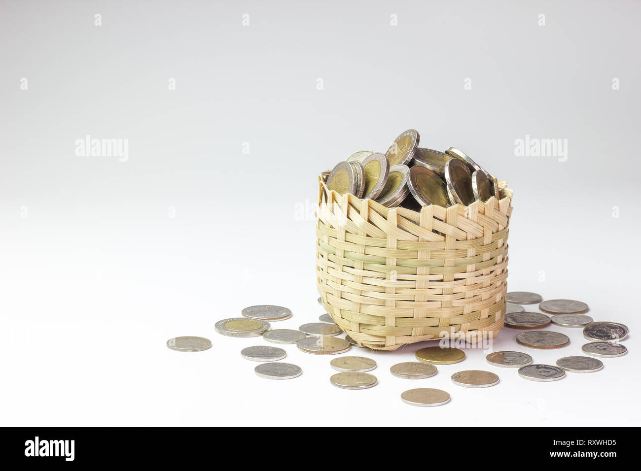 Many coin in a bamboo basket on white background. Concept financial or ...
