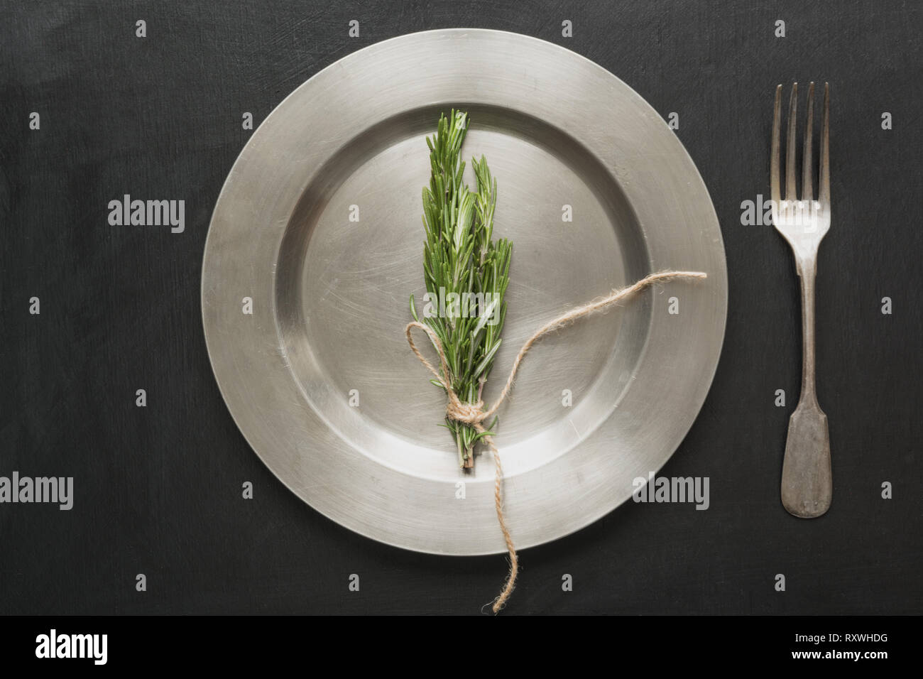 Vintage table place setting with rosemary on black. Top view. Concept ...