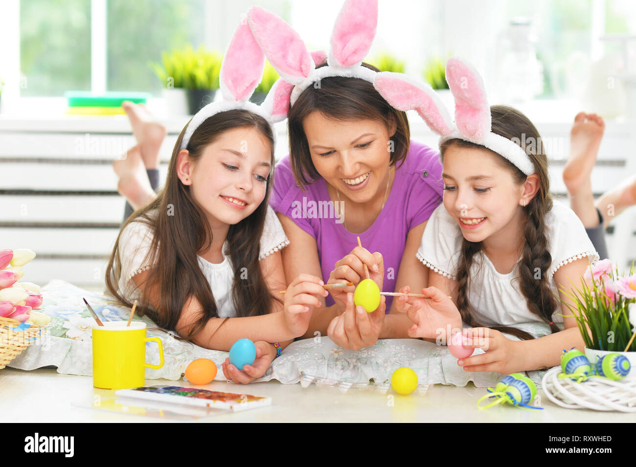 Portrait of cute twins with mother wearing rabbit ears Stock Photo - Alamy