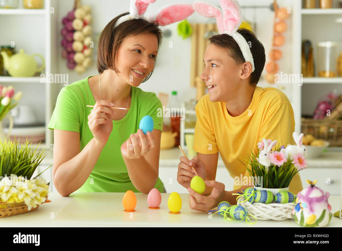 Happy mother and son wearing rabbit ears Stock Photo - Alamy