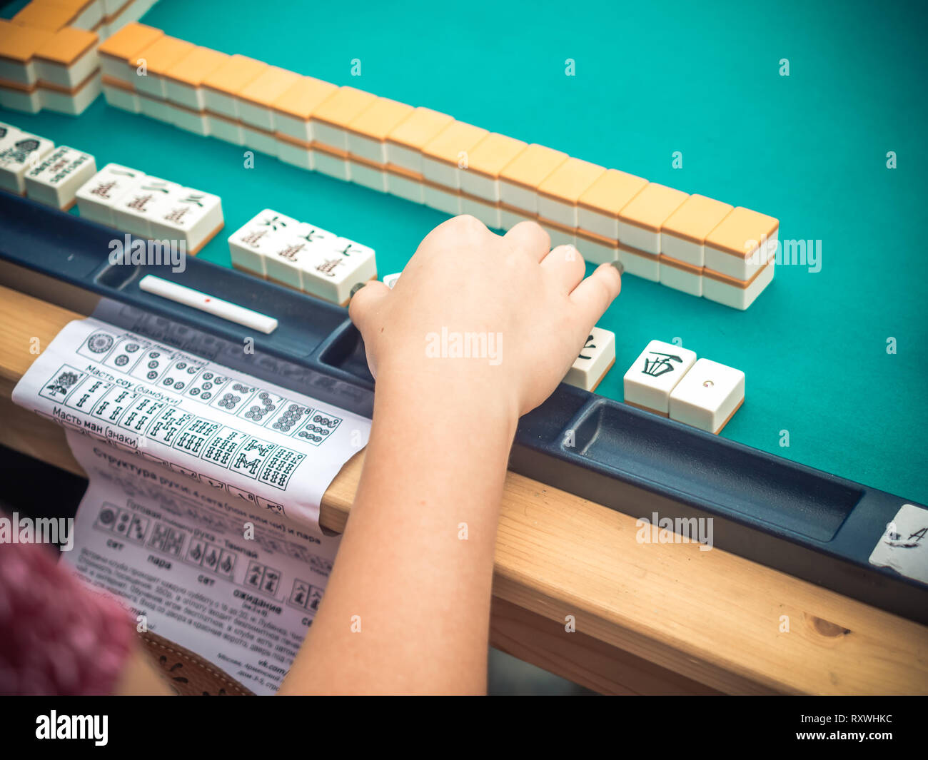 Japanese festival in Moscow. Young people playing mahjong asian tile ...
