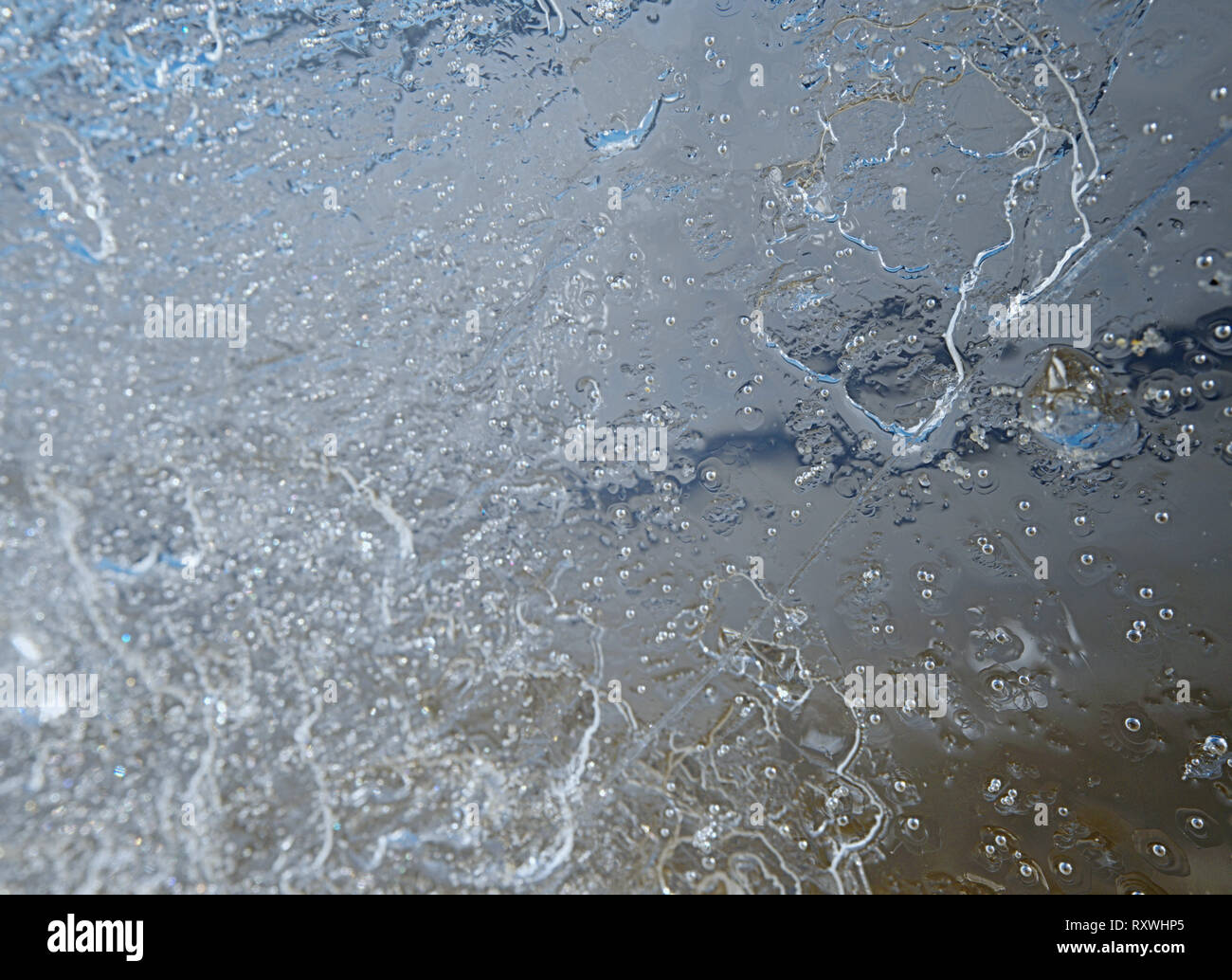 Sun rays caught in cracks in ice piece. Broken floe turn against to ...