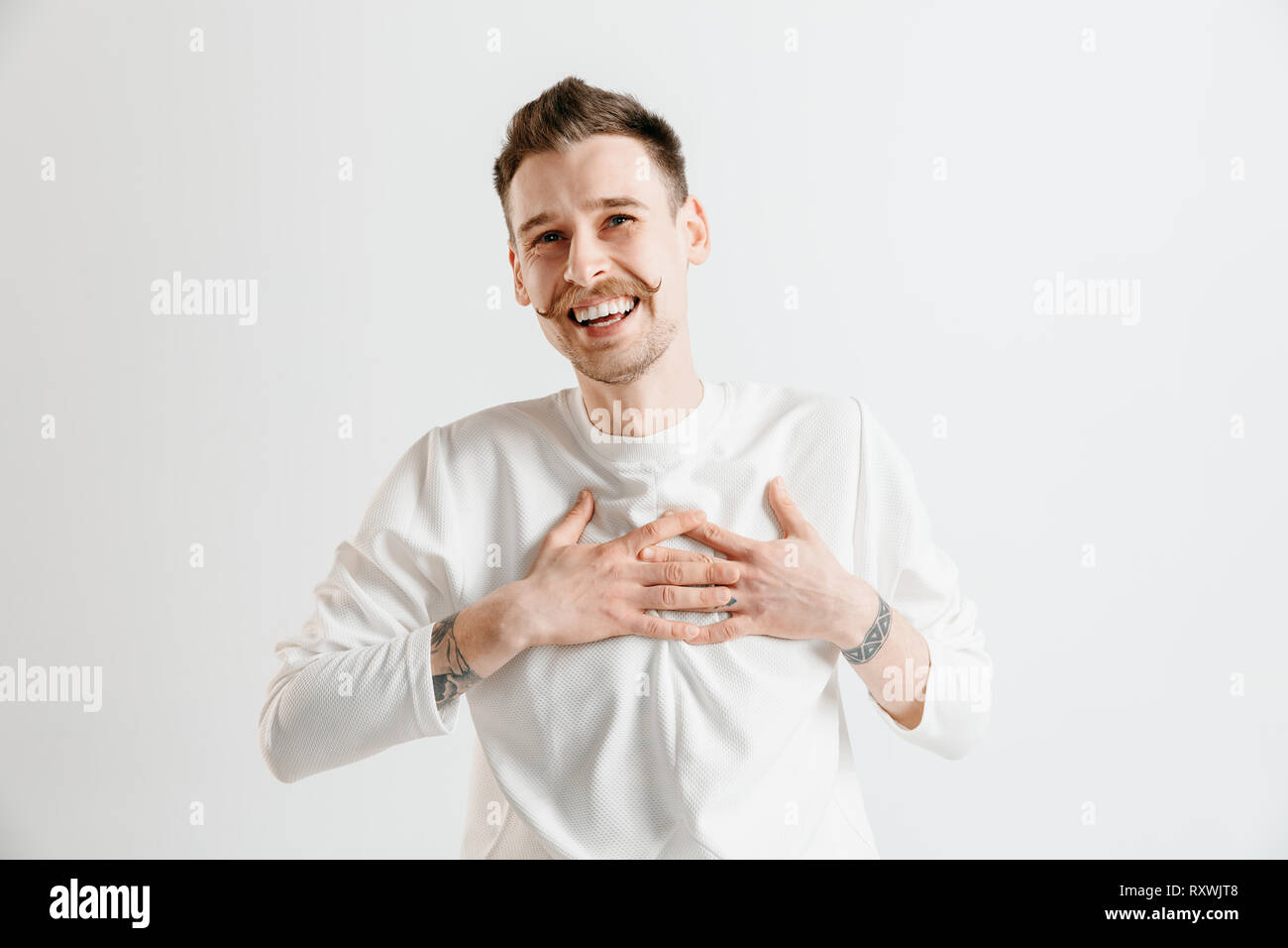 Happy business man standing, smiling isolated on gray studio background ...