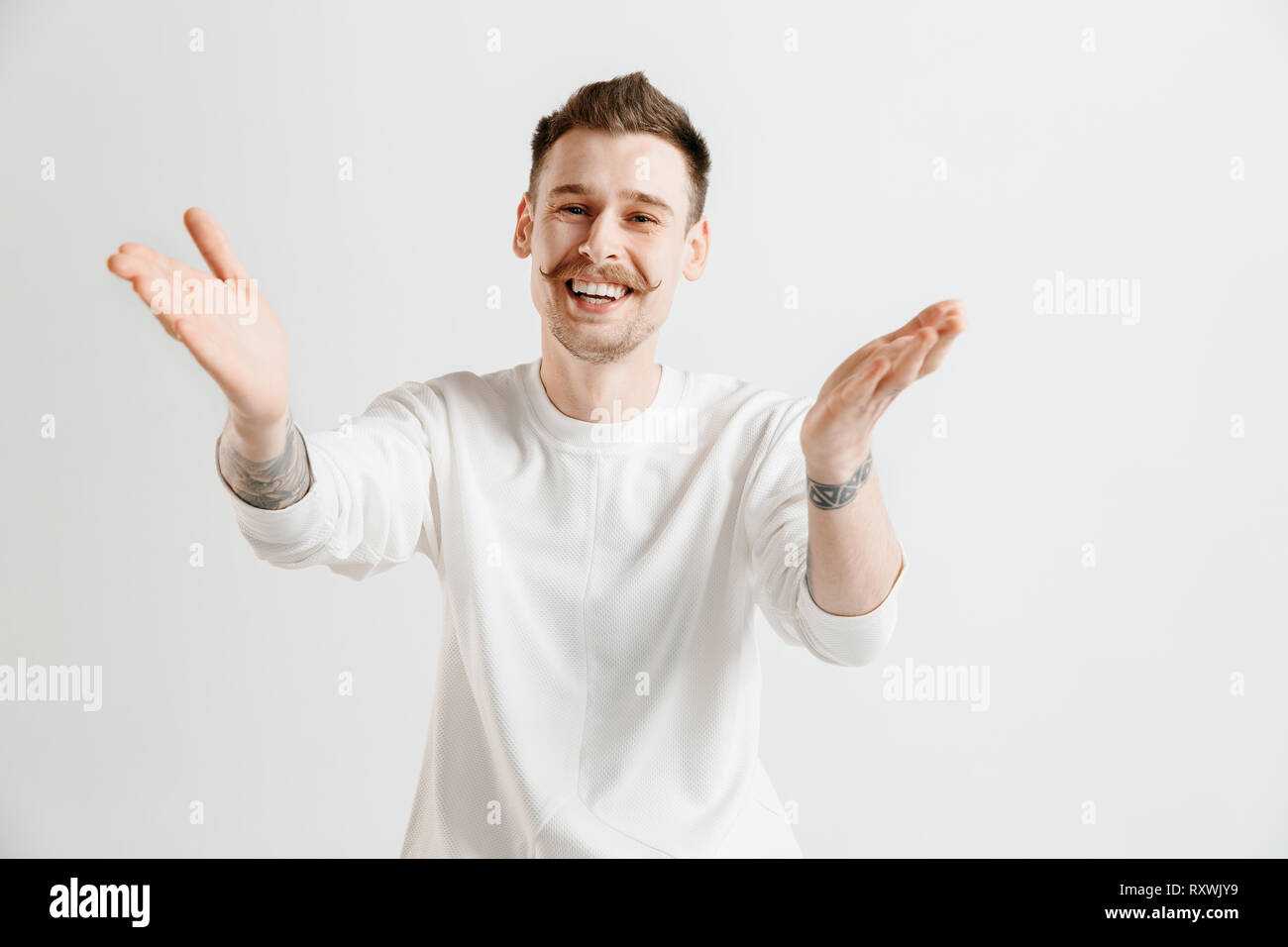 Happy business man standing, smiling isolated on gray studio background ...