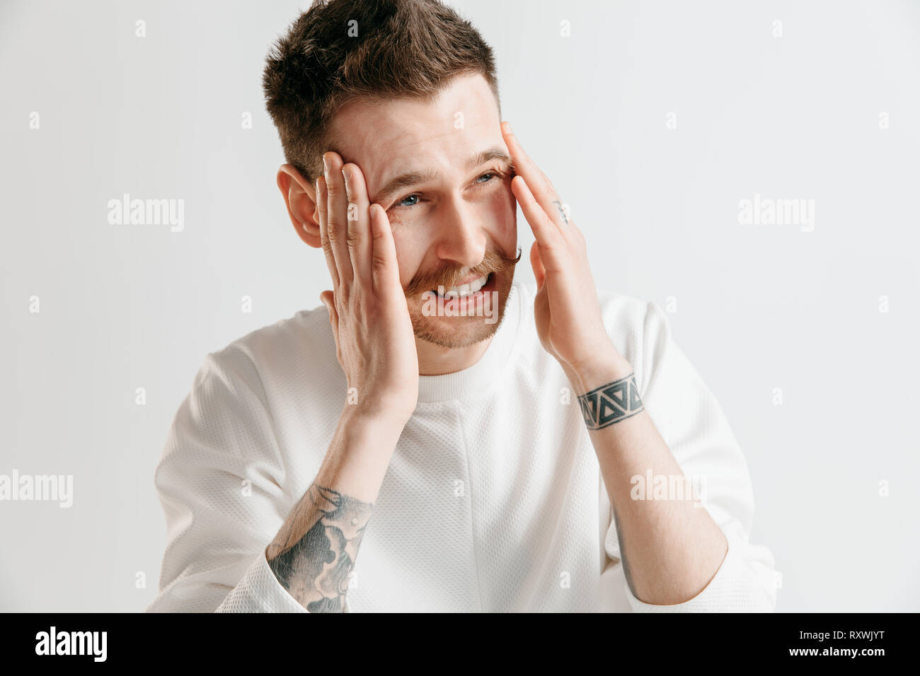 Man having headache. Business man standing with pain isolated on gray ...