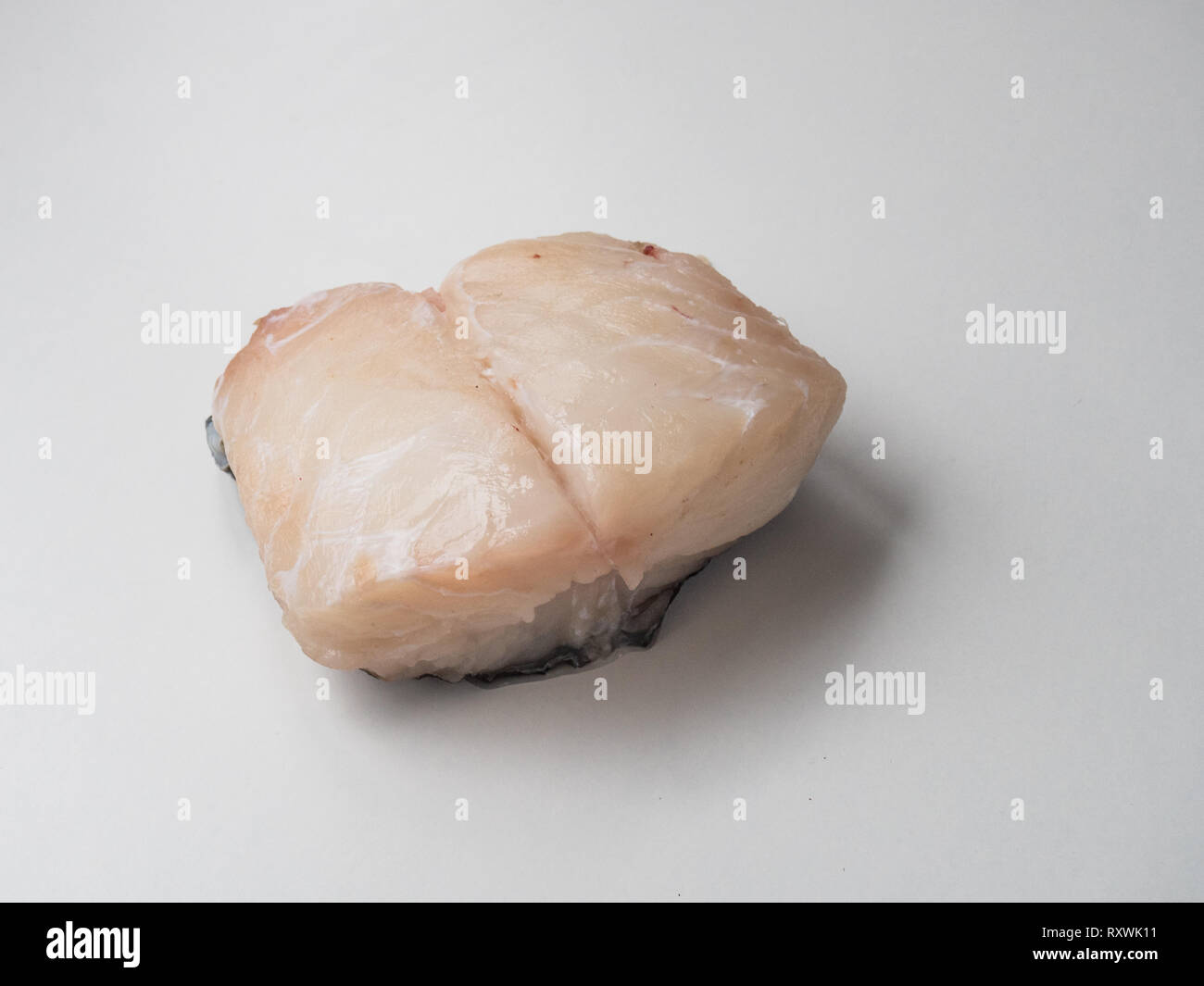 Raw cod on white background Stock Photo - Alamy