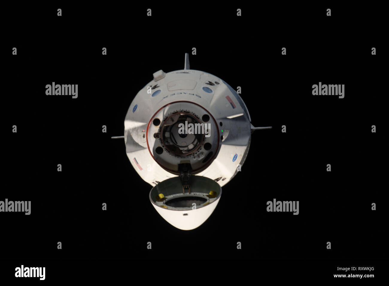 The unmanned SpaceX Dragon commercial crew capsule opens the nose cone ...